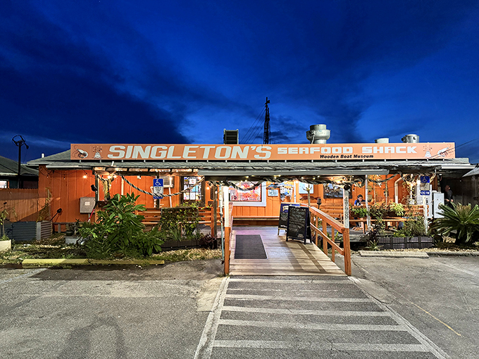 Sunset or seafood? At Singleton's, you don't have to choose! This vibrant orange shack glows like a beacon for hungry sailors and landlubbers alike.