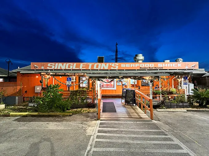 Sunset or seafood? At Singleton's, you don't have to choose! This vibrant orange shack glows like a beacon for hungry sailors and landlubbers alike.