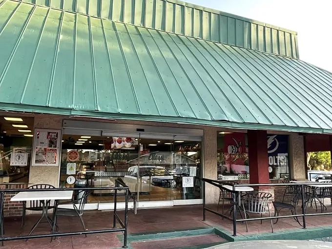 Welcome to carb heaven! Alessi Bakery's iconic green roof beckons like a beacon of buttery bliss, promising sweet salvation from the Florida heat.