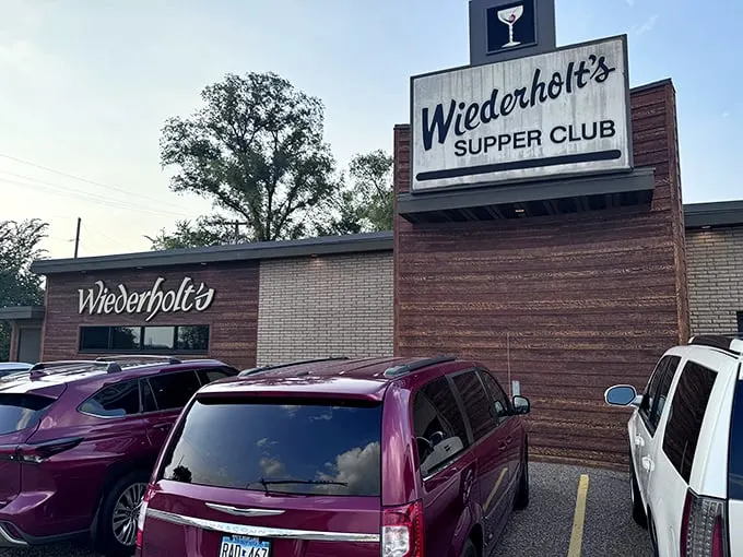 A neon martini glass winks at you from above – Wiederholt's Supper Club is ready to shake up your evening, one classic cocktail at a time.