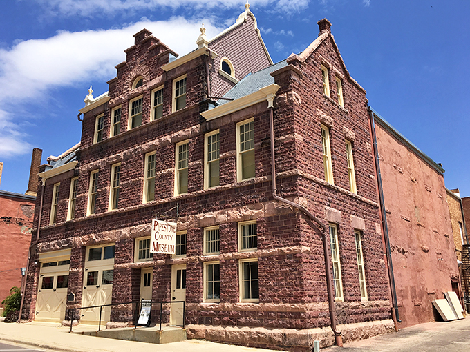 "Who needs a red carpet when you've got red stone?" This majestic pipestone building is the architectural equivalent of a power suit – impressive and unforgettable.