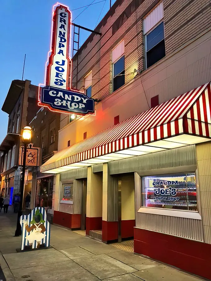 Step right up to the sweetest show in town! Grandpa Joe's neon sign beckons like a lighthouse for sugar-starved sailors, promising a voyage into confectionery bliss.