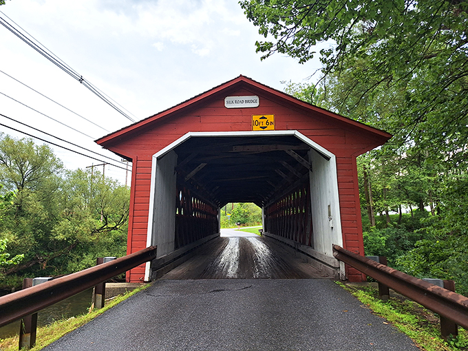 Step into a time machine, folks! This vibrant red gateway isn't just a bridge—it's a portal to Vermont's charming past.