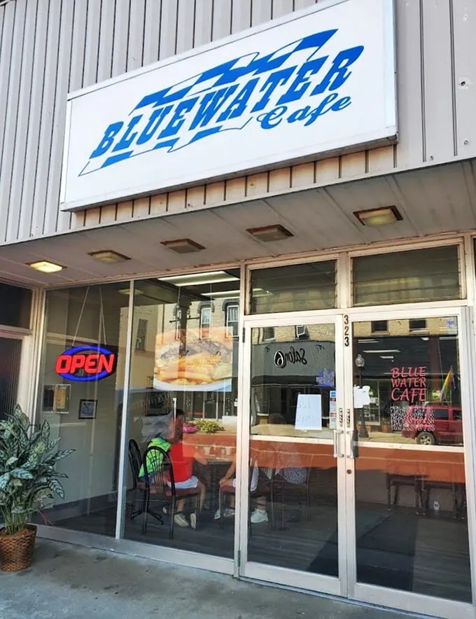 A sign that says "come on in" without saying a word. Bluewater Cafe's exterior promises a classic diner experience with a dash of small-town charm.