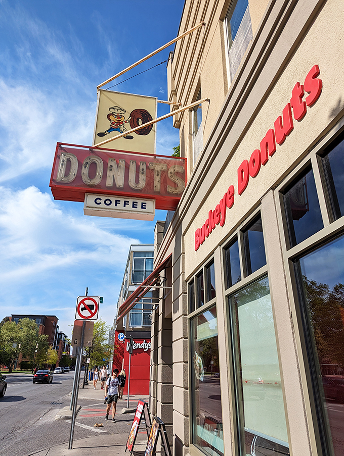A beacon of hope for the hungry! Buckeye Donuts' retro sign promises sweet salvation 24/7, like a lighthouse guiding sugar-starved ships to shore.