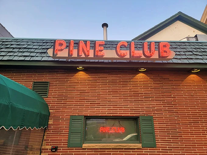 A neon beacon of culinary delight! The Pine Club's iconic sign promises a journey back to the golden age of supper clubs, where steaks sizzle and martinis flow.