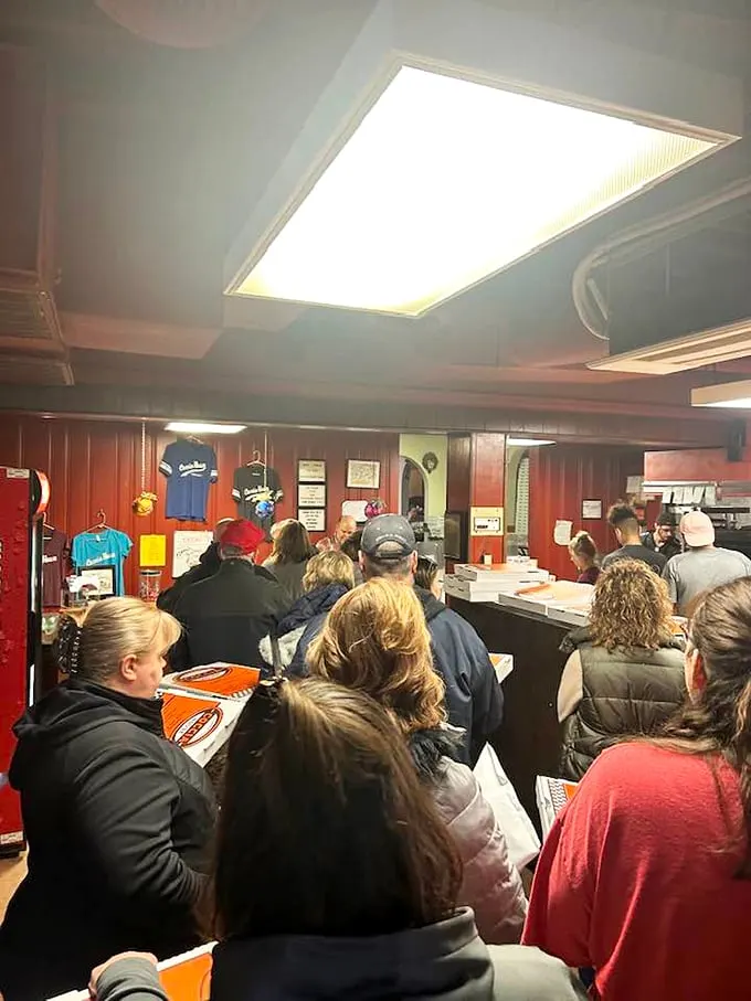 Pizza rush hour! These hungry patrons know the secret to happiness is just a slice away.