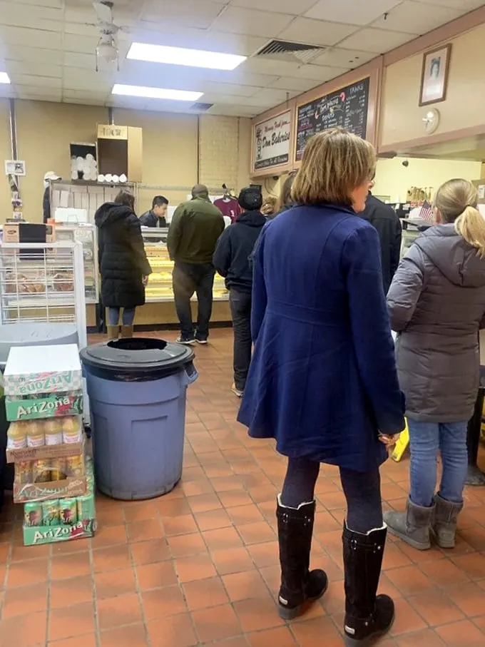 The line forms here for happiness. These patient patrons know that good things come to those who wait (for donuts).