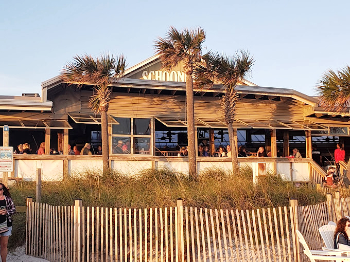 Schooners' beachfront dining: Where 'feet in the sand' isn't just allowed, it's encouraged. Seafood never had a better view!