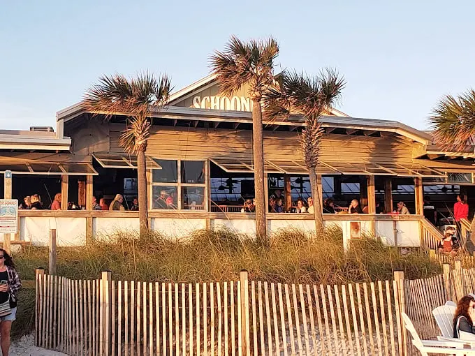 Schooners' beachfront dining: Where 'feet in the sand' isn't just allowed, it's encouraged. Seafood never had a better view!