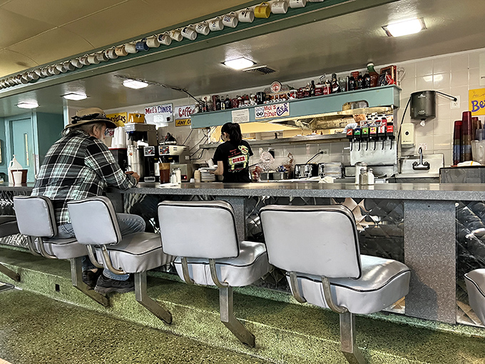 Counter seats: The front-row tickets to the greatest show on earth – breakfast being made with a side of diner drama.