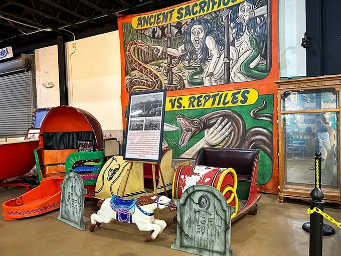 Ancient sacrifices vs. reptiles? This carnival banner proves that showmanship has no bounds – or taste limits.