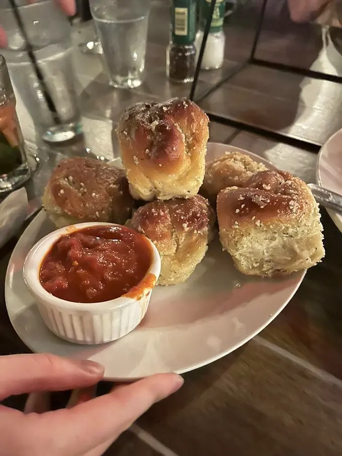 Garlic knots: the unsung heroes of Italian cuisine. These golden nuggets of garlicky goodness are like edible stress balls, but tastier.