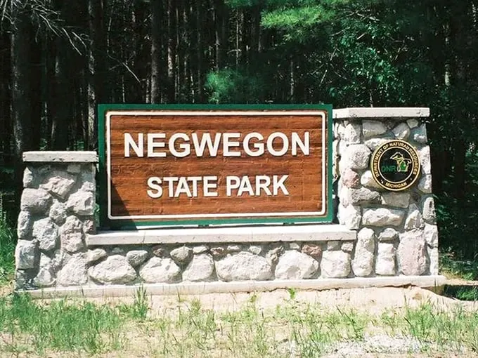 Welcome to Negwegon, where even the sign looks like it's on vacation. Rustic charm meets Great Lakes grandeur in this hidden paradise.