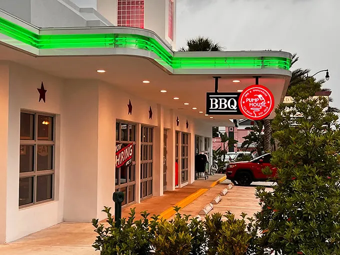Pumphouse BBQ: Neon dreams and smoky schemes! This modern facade hides a carnivore's paradise waiting to be explored.
