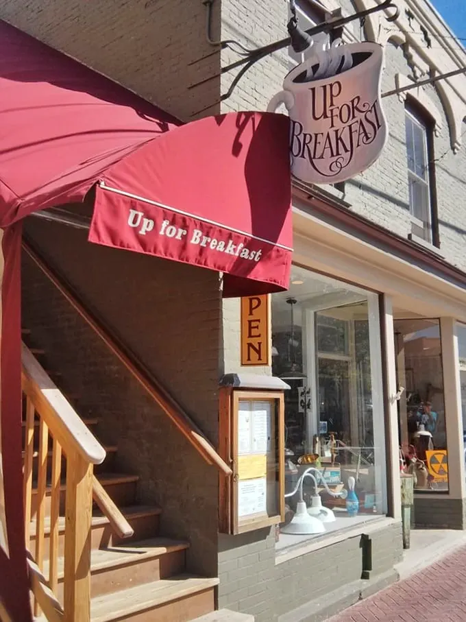 Stairway to breakfast heaven! This cozy spot serves up plates so hearty, you might need a nap before tackling the descent.
