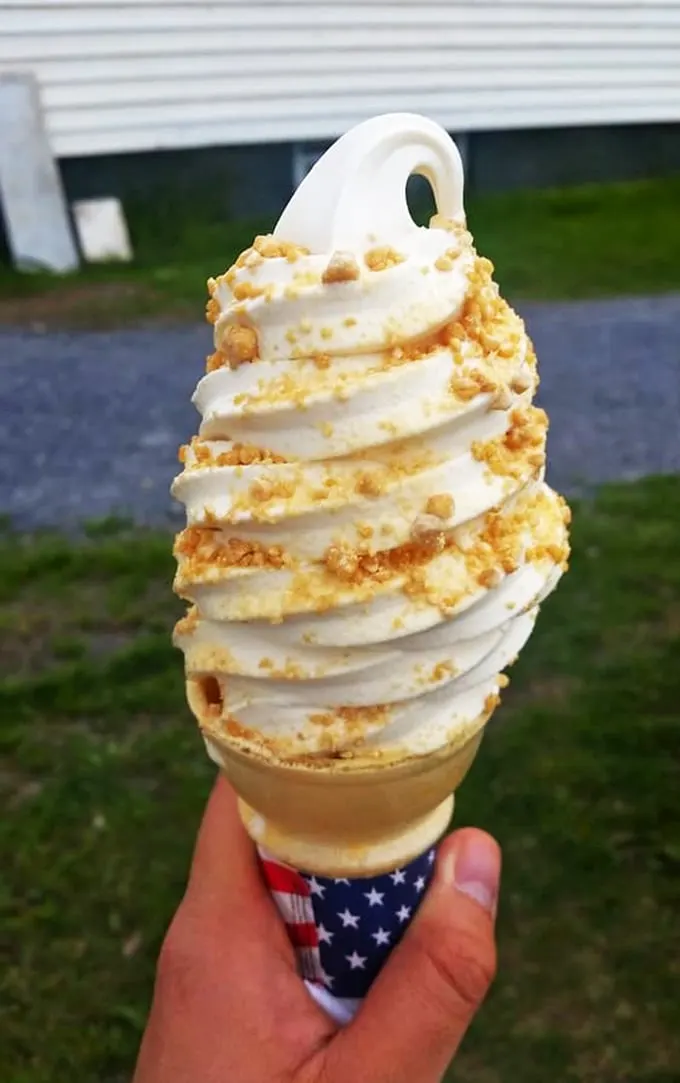Behold, the golden tower of joy! This maple creemee is what dreams are made of – if dreams wore sprinkles and came in a cone.
