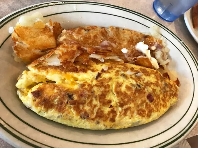 Behold, the omelet of champions! Packed with goodies and cooked to perfection, it's a breakfast lover's dream come true.