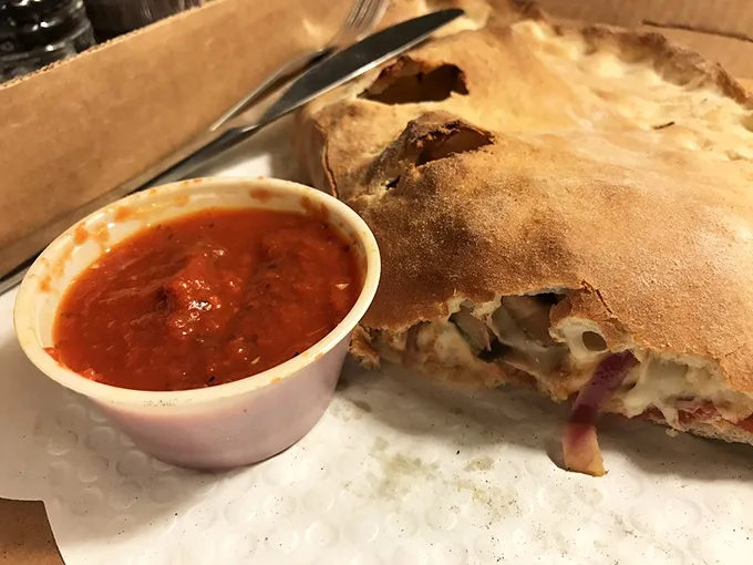 "The calzone that ate Manhattan." This golden-brown behemoth is stuffed with enough cheesy goodness to make you consider moving to Vermont permanently.