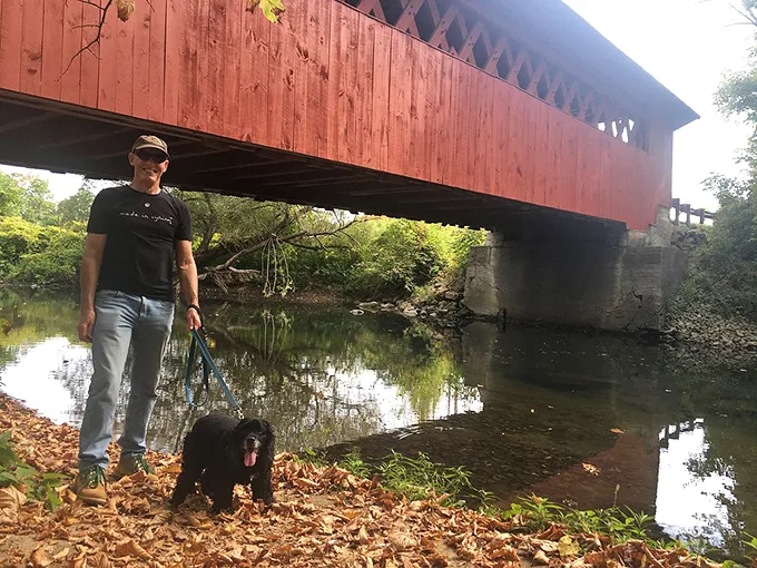 Man's best friend leads the way to adventure. This bridge isn't just crossing water—it's spanning generations of tail-wagging explorers.