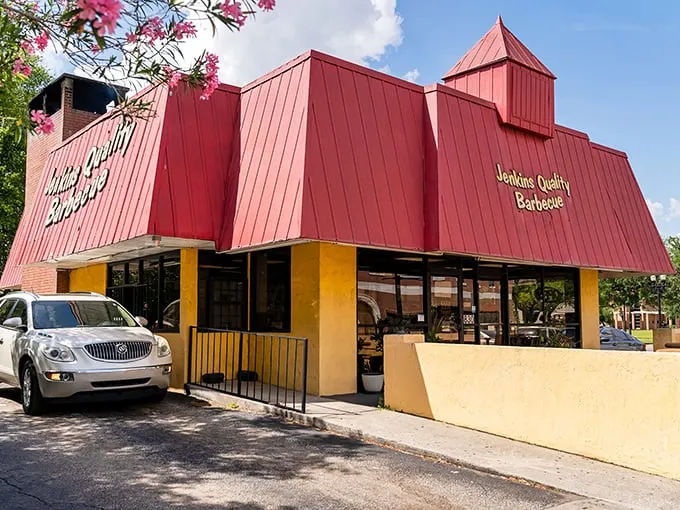Jenkins Quality Barbecue: Red roof, yellow sign, flavor divine! This colorful beacon promises a rainbow of BBQ delights.