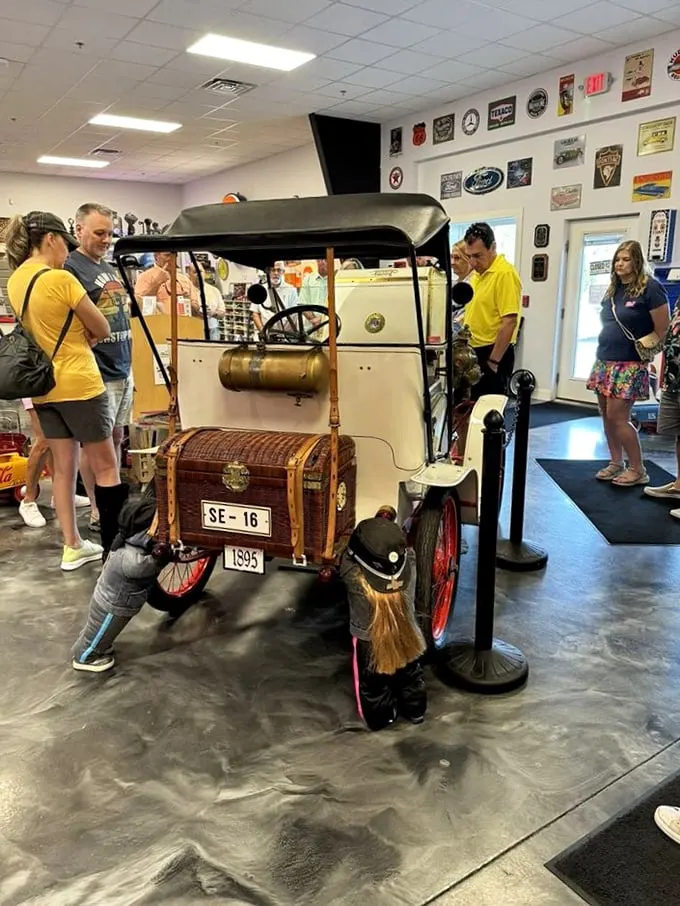 Step right up, folks! This charming vintage car is drawing admirers like moths to a very shiny, very retro flame. Time travel has never looked so stylish!