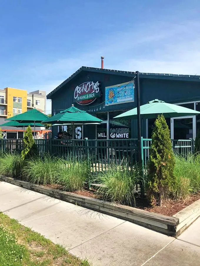 Roadside oasis alert! Crunchy's green facade is a refreshing sight for travel-weary eyes.
