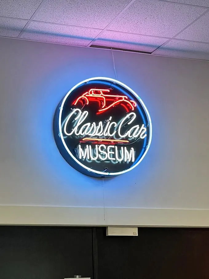 Neon dreams come true! This glowing sign is like a beacon in the night, guiding car lovers to their happy place. Who needs GPS when you've got nostalgia?