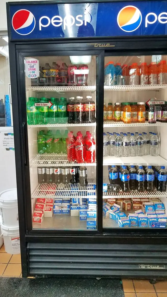 Thirst quenchers galore! This fridge is stocked like a liquid rainbow, ready to wash down your donut feast with fizzy, fruity flair.
