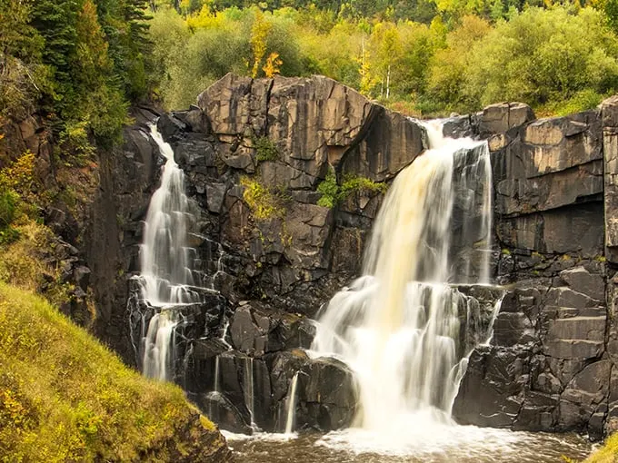 Nature's grand entrance: Rugged cliffs and crystal-clear waters welcome you to Grand Portage State Park. It's like Mother Nature rolled out the red carpet!