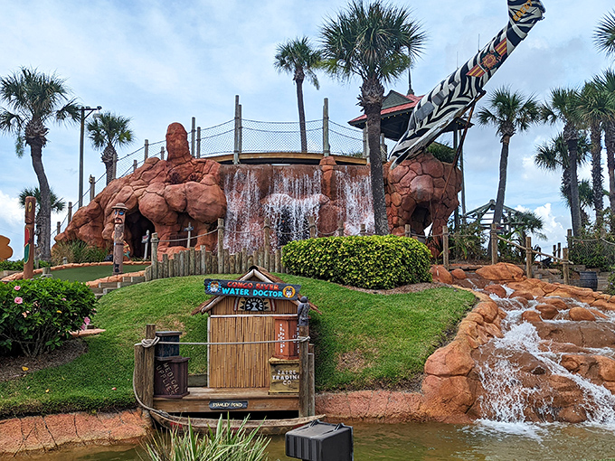 Welcome to the Jurassic Park of mini-golf! This waterfall isn't just for show – it's nature's way of saying, "You're in for a wild ride!"
