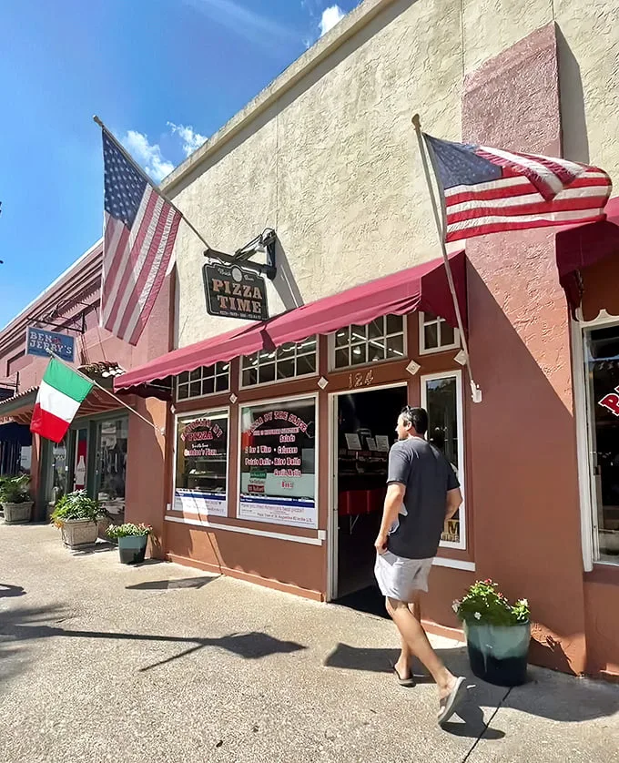 Welcome to pizza paradise! This unassuming storefront is like Clark Kent's phone booth – step inside for a super transformation of your taste buds.