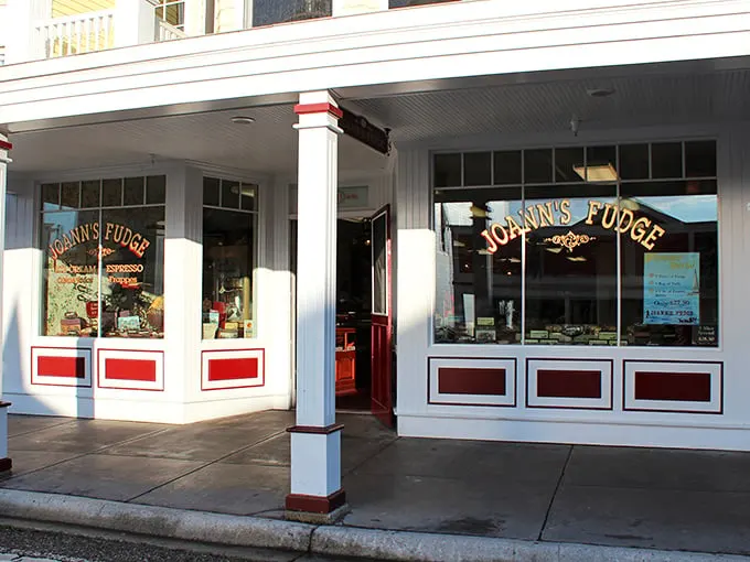 Step into a time machine disguised as a fudge shop! Joann's Fudge beckons with its classic white facade and red trim, promising sweet nostalgia inside.