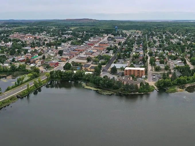 Chisholm: Where Main Street meets Mother Nature. This aerial view showcases the town's perfect blend of urban charm and natural beauty, like a Norman Rockwell painting come to life.