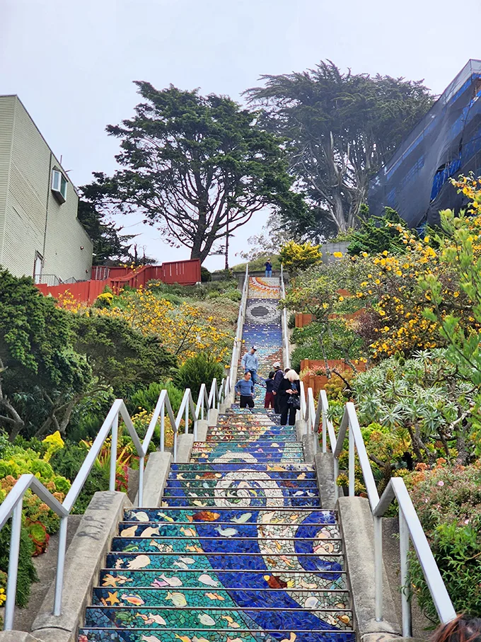 Step into a world of wonder! These mosaic-covered stairs are like a Willy Wonka fever dream, minus the chocolate river but with extra whimsy.
