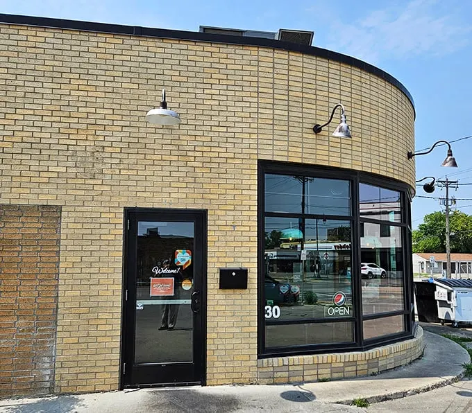 Brew Bird's curved brick exterior isn't just a wall—it's a warm hug welcoming you to flavor town. This unassuming facade hides a world of culinary delights waiting to be discovered.