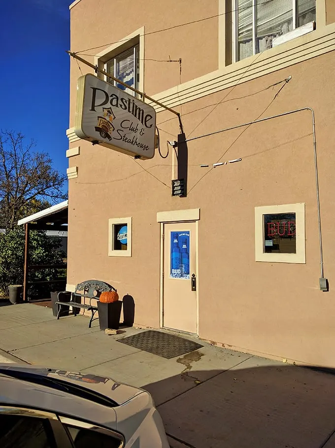 Welcome to flavor town! The Pastime Club & Steakhouse's unassuming exterior hides a world of culinary delights, proving you should never judge a book by its cover – or a steakhouse by its siding.