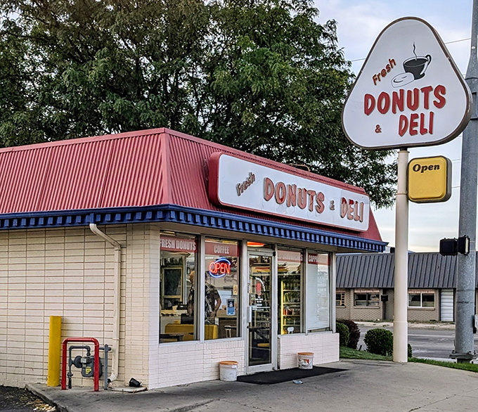 A donut oasis in the desert! This unassuming shop, with its cheery red roof and retro sign, promises sweet salvation for sugar-seekers.