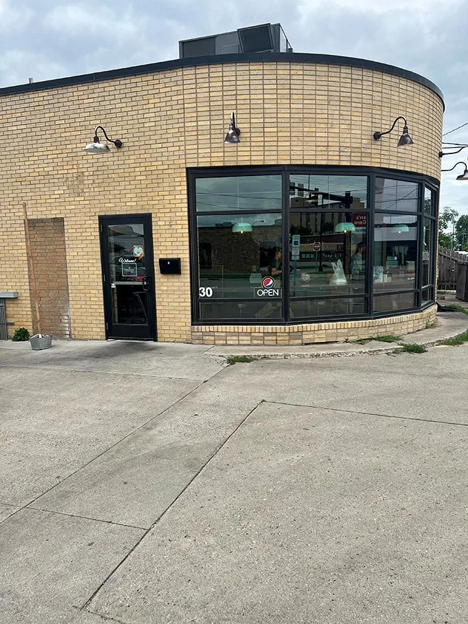 Brew Bird's curved brick exterior isn't just a wall—it's a warm hug welcoming you to flavor town. This unassuming facade hides a world of culinary delights waiting to be discovered.