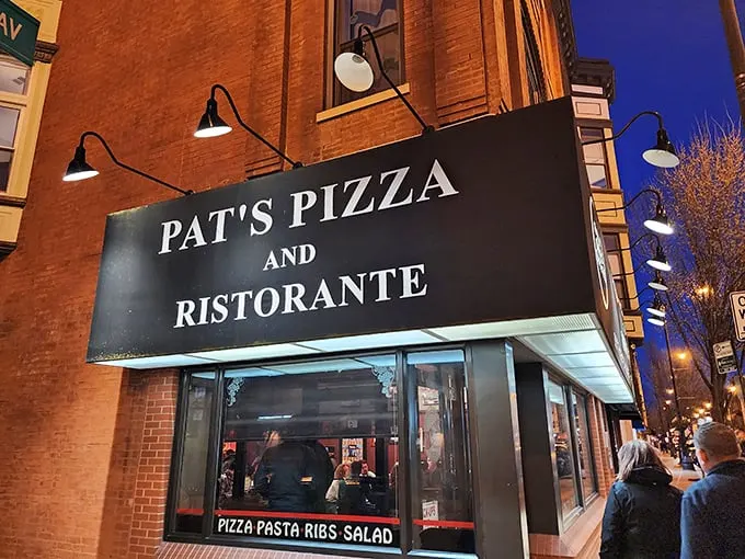 A beacon of pizza perfection! Pat's Pizza and Ristorante stands proud against the Chicago night sky, promising a slice of heaven within its brick walls.