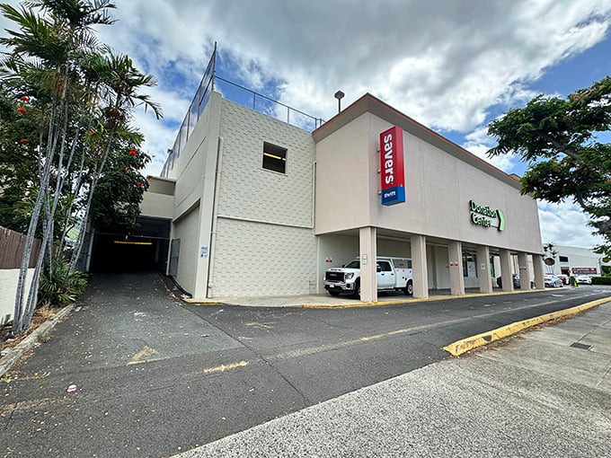 Welcome to bargain paradise! Savers' exterior promises a treasure trove of deals, nestled between palm trees and parked cars. It's like a retail oasis in the urban jungle.