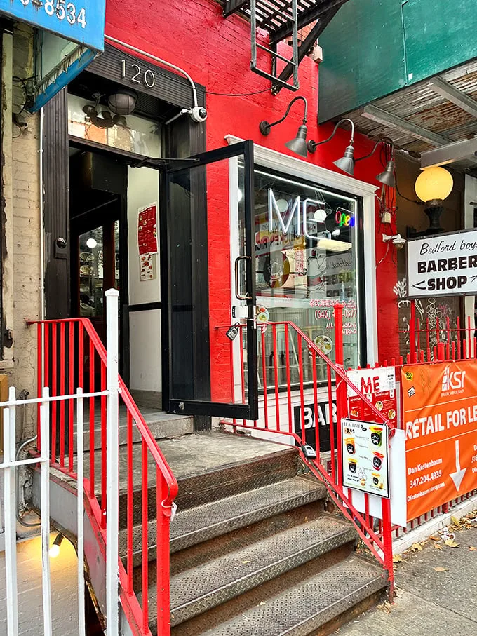 A splash of red in the urban jungle! This vibrant storefront promises a chicken adventure that'll ruffle your feathers in the best way possible.