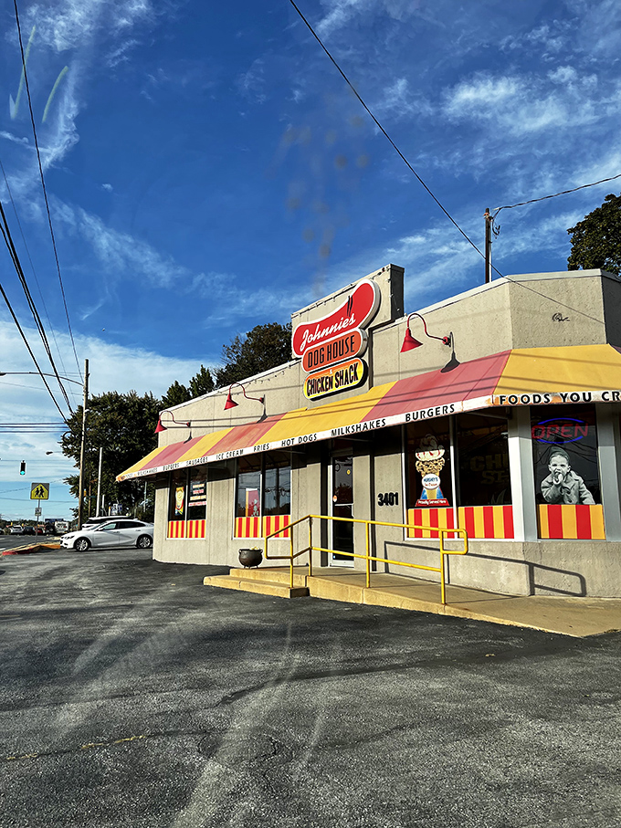 Welcome to flavor town! Johnnie's Dog House and Chicken Shack beckons with its cheerful awning and promise of comfort food that'll make your taste buds do a happy dance.