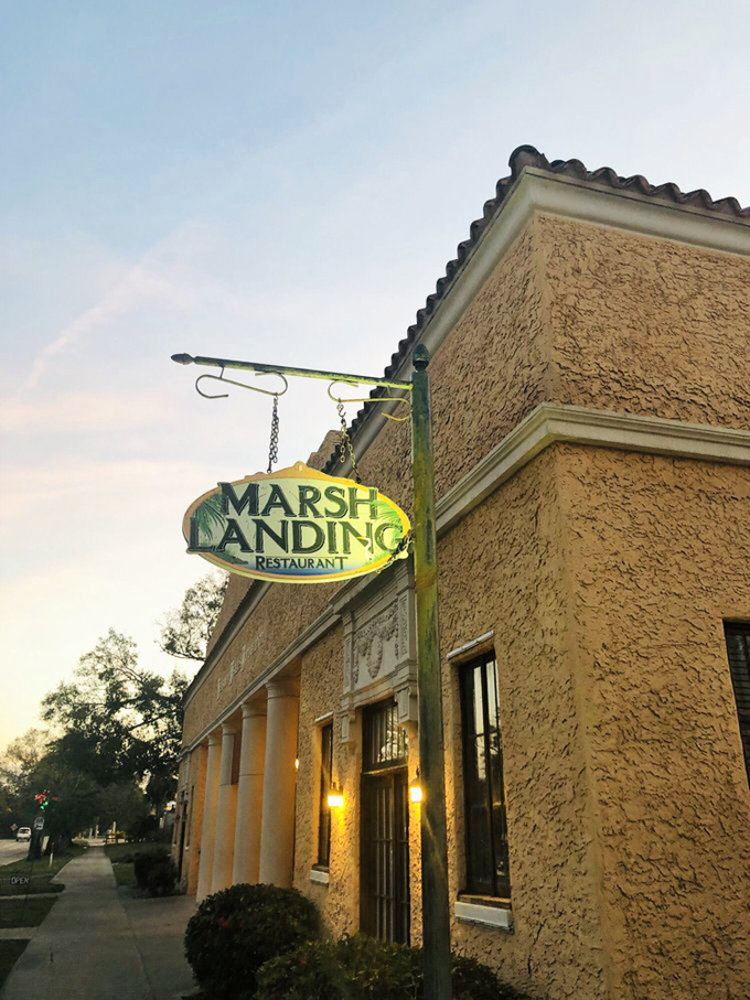 A Spanish mission meets Southern charm! Marsh Landing's exterior promises a culinary adventure that's as inviting as a cool breeze on a hot Florida day.