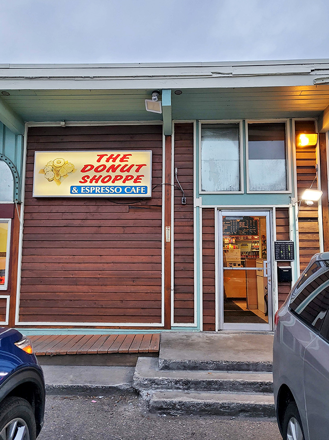 A mint-green time machine! This charming exterior promises a journey back to simpler days when donuts ruled the breakfast kingdom.