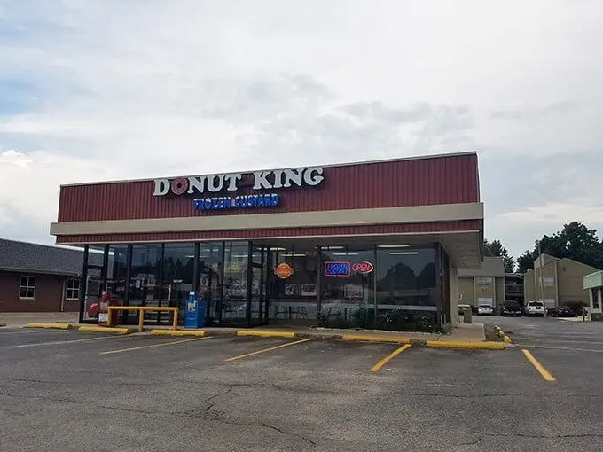 Behold, the neon-lit palace of pastry perfection! Donut King's sign shines like a beacon, guiding sugar-seekers to their glazed destiny.