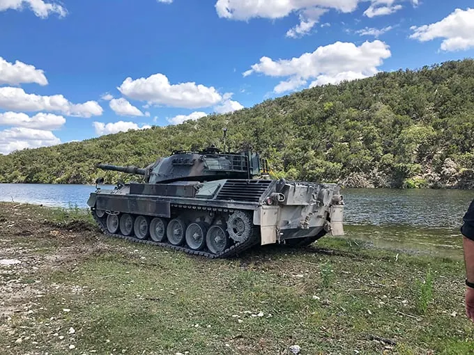 "Is that a tank or just Texas-sized lawn ornament?" This beast of steel and firepower sits pretty by a serene lake, ready for action or a photoshoot.