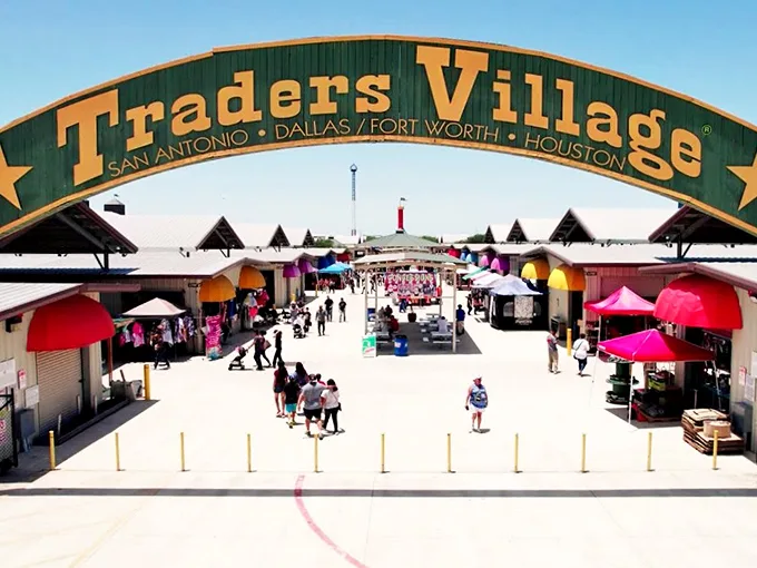 Welcome to bargain hunter's paradise! Traders Village's iconic green and yellow entrance beckons shoppers to a world of treasures and treats.