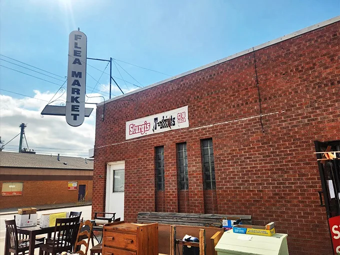 Step right up, folks! This brick behemoth isn't just a building; it's a portal to treasure-hunting paradise. The "FLEA MARKET" sign practically winks at you, promising adventures in antiquing.
