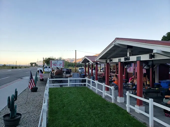 Welcome to barbecue paradise! Copper Top BBQ's charming exterior promises smoky delights against a backdrop of mountain majesty.